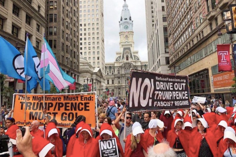 PHOTOS: Protesters Greet Mike Pence in “Handmaid's Tale” Costumes